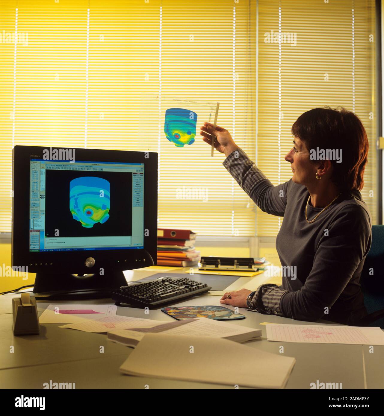 Nuclear power station design. Engineer displaying computer models ...