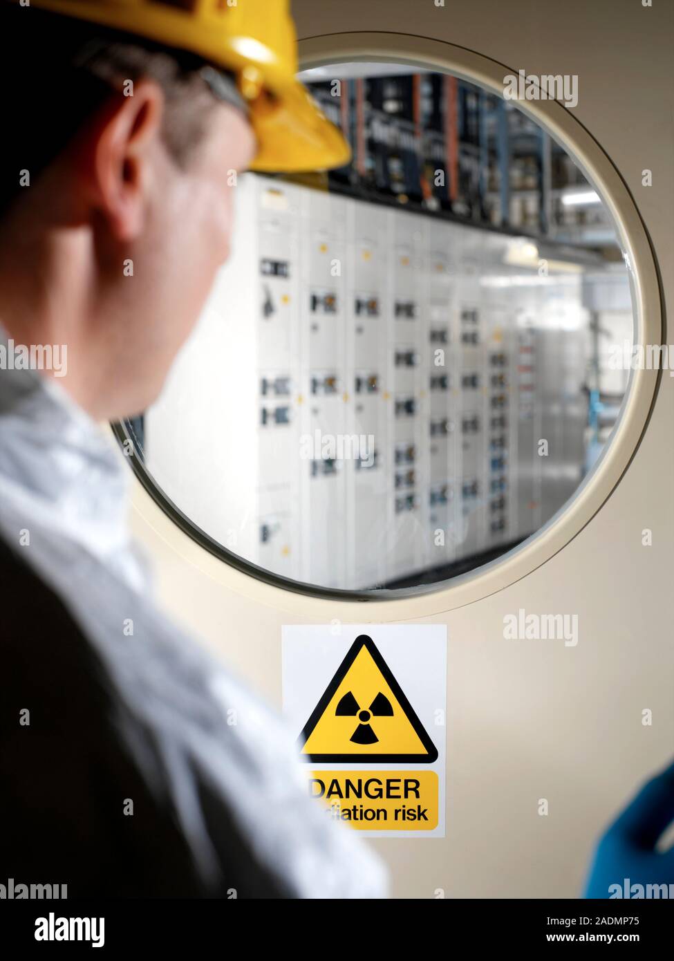 Nuclear power station. Engineer behind the door of a control room at a ...