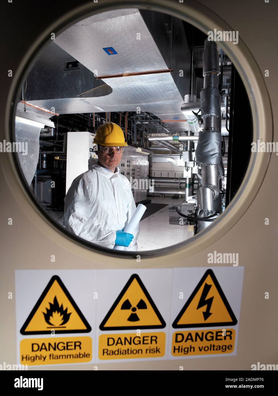 Nuclear power station. Engineer behind the door of a control room at a ...