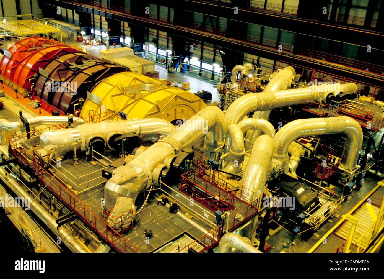 Nuclear power station. Turbine (left) and steam generator (right) in a ...