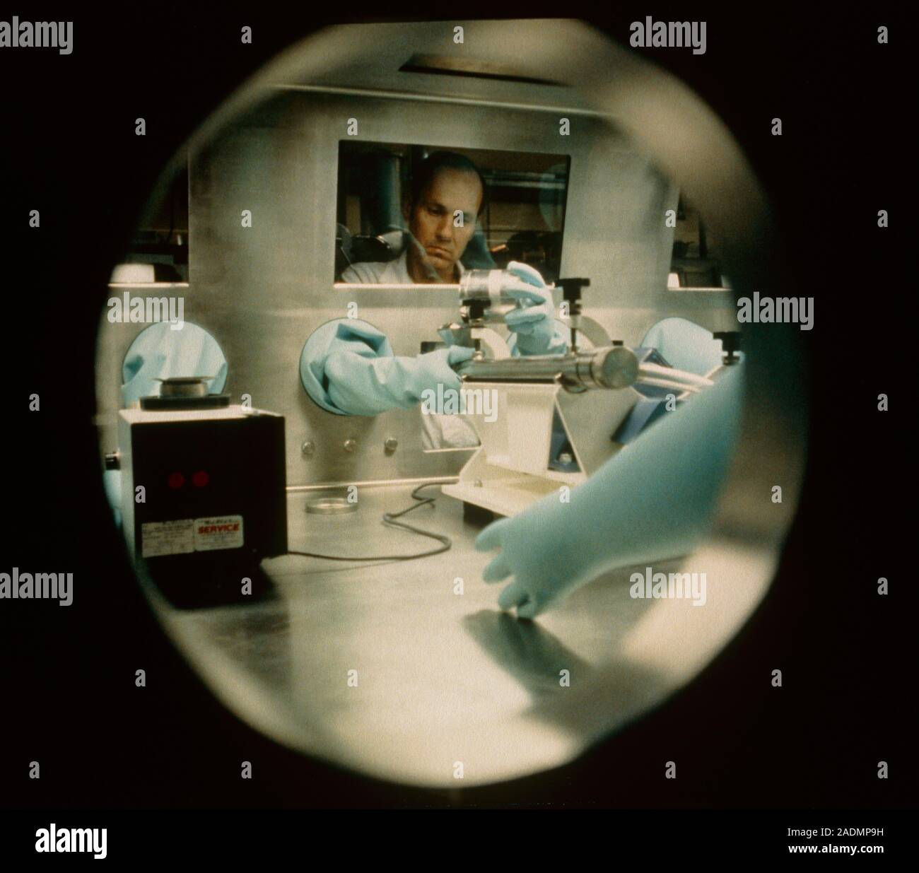 Worker handling plutonium in a glove box at a processing plant at Los ...