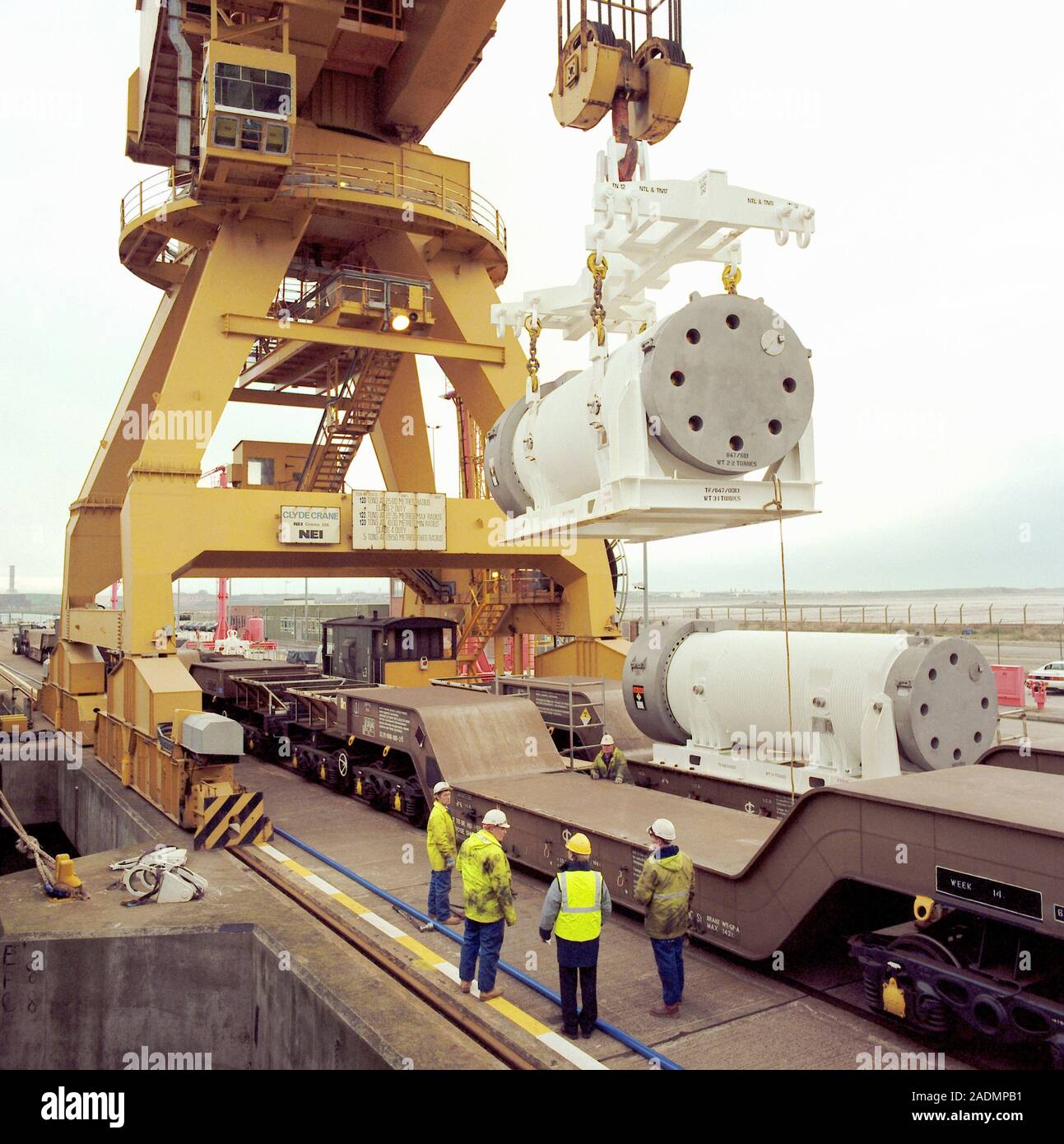 MODEL RELEASED. Transporting nuclear reactor fuel. Workers watch a ...
