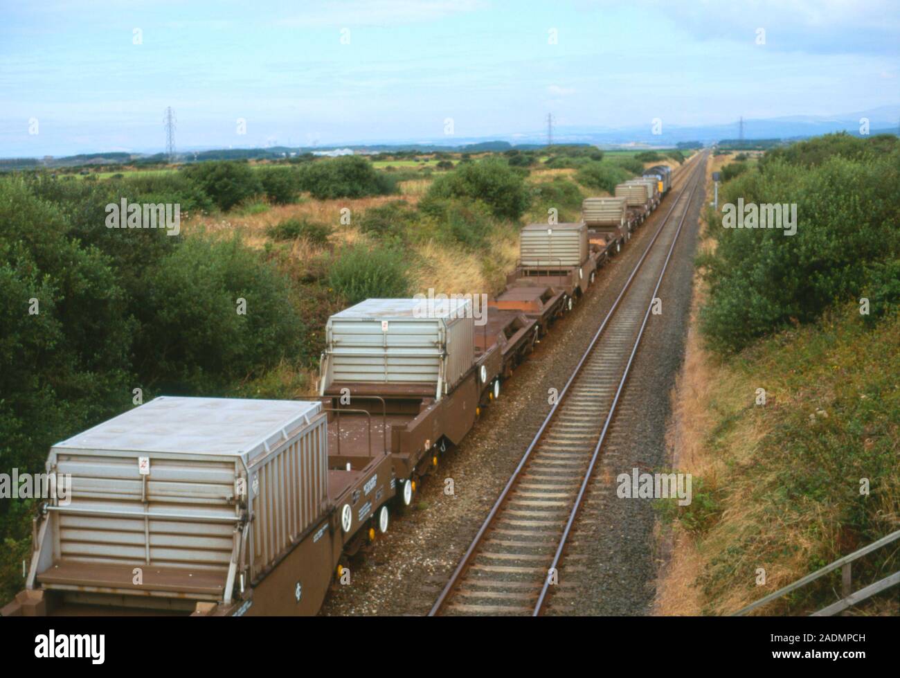 Transporting nuclear waste. A train pulling trucks carrying nuclear ...