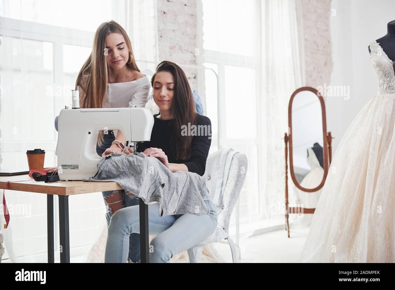 Calm mood. Two female fashion designers works on the new clothes in the ...