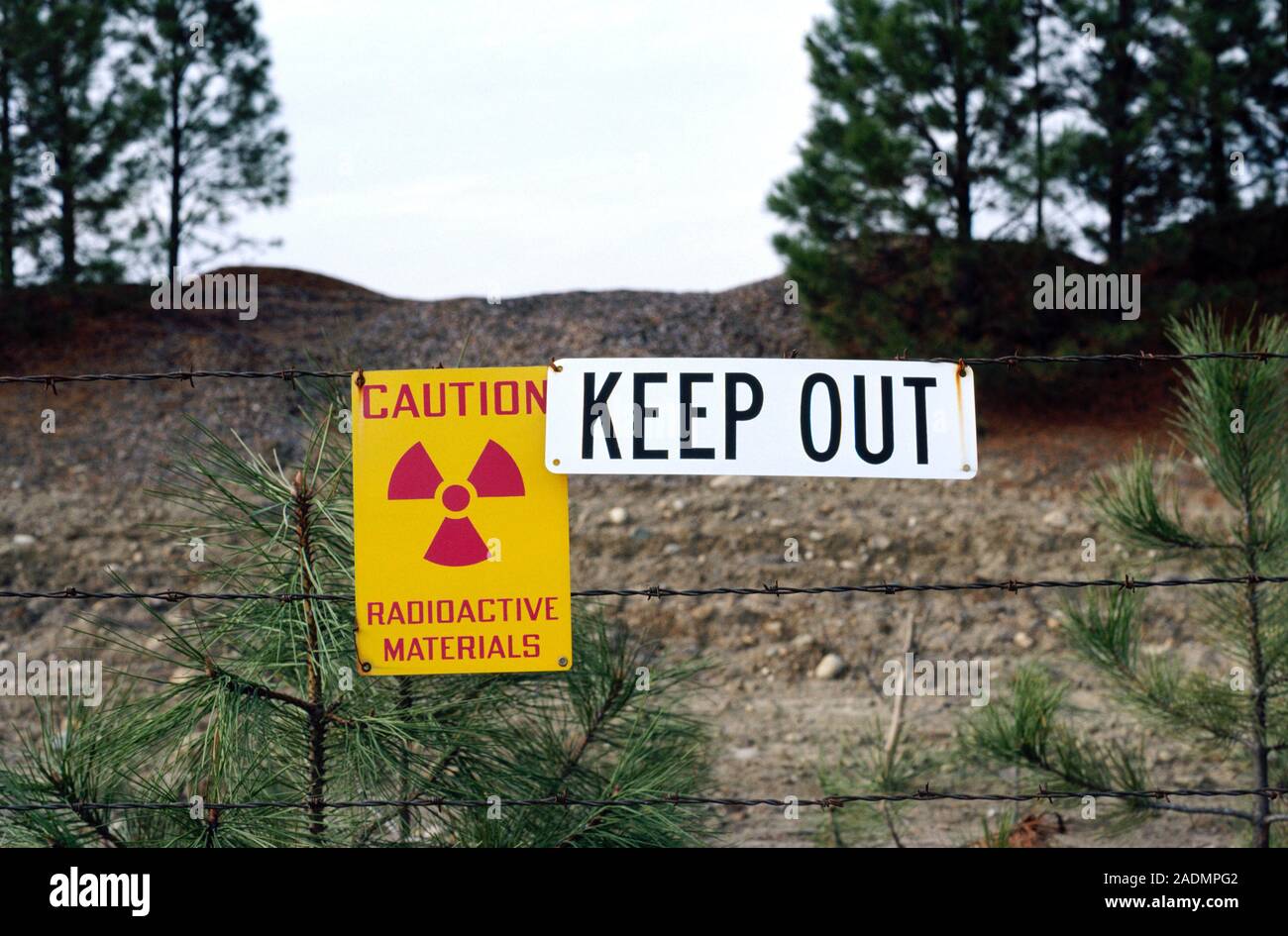 Radioactive pollution. Radiation warning signs near an area of uranium ...