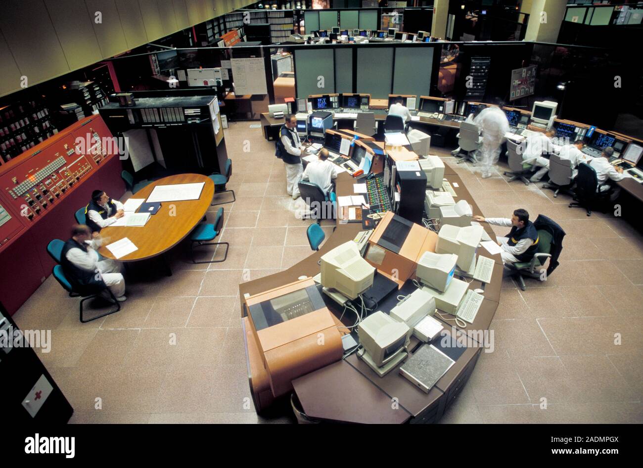 Nuclear fuel reprocessing. Workers in a control room at a centre for ...
