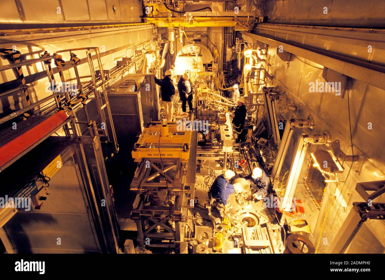Nuclear fuel reprocessing. Engineers installing automated machinery for ...