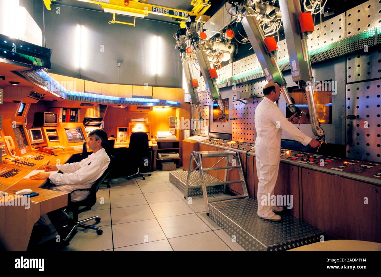 Nuclear fuel reprocessing. Workers using robotic remote-handling ...