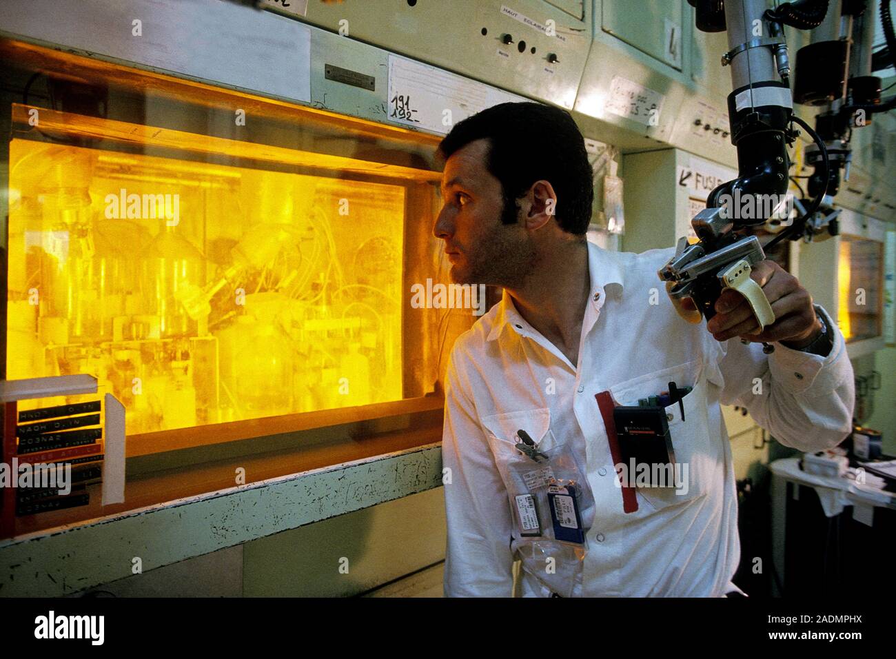 Remote handling of radioactive waste. Nuclear technician using a ...
