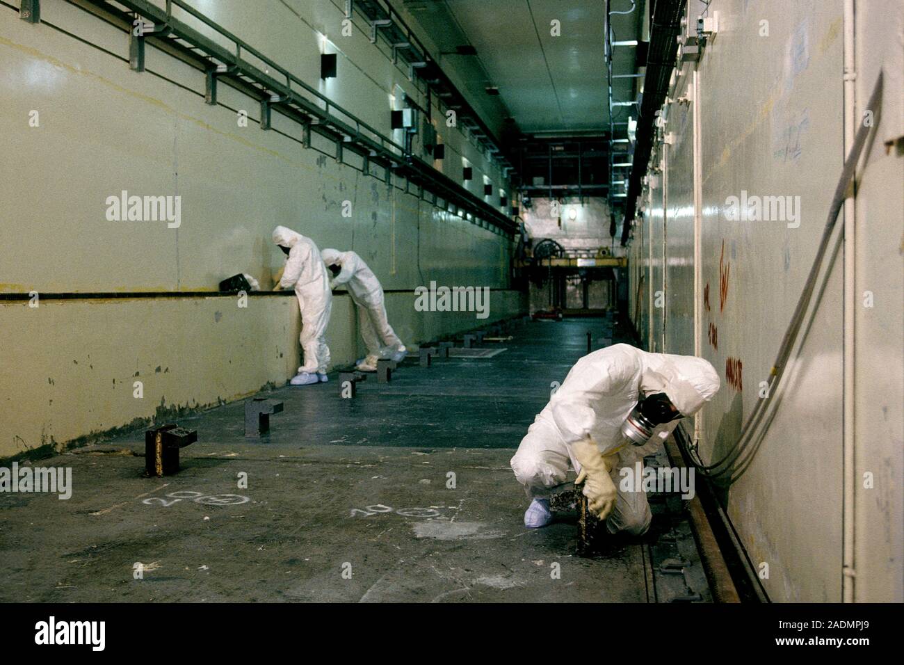 Nuclear decontamination workers. The workers are wearing sealed ...