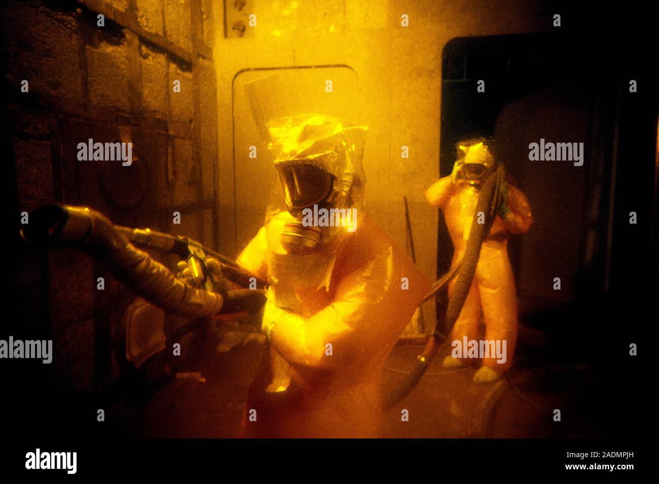 Nuclear decontamination workers using sandblasting equipment. The ...