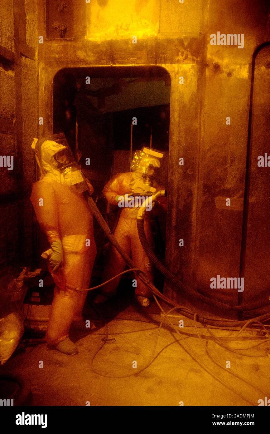 Nuclear decontamination workers using sandblasting equipment. The ...