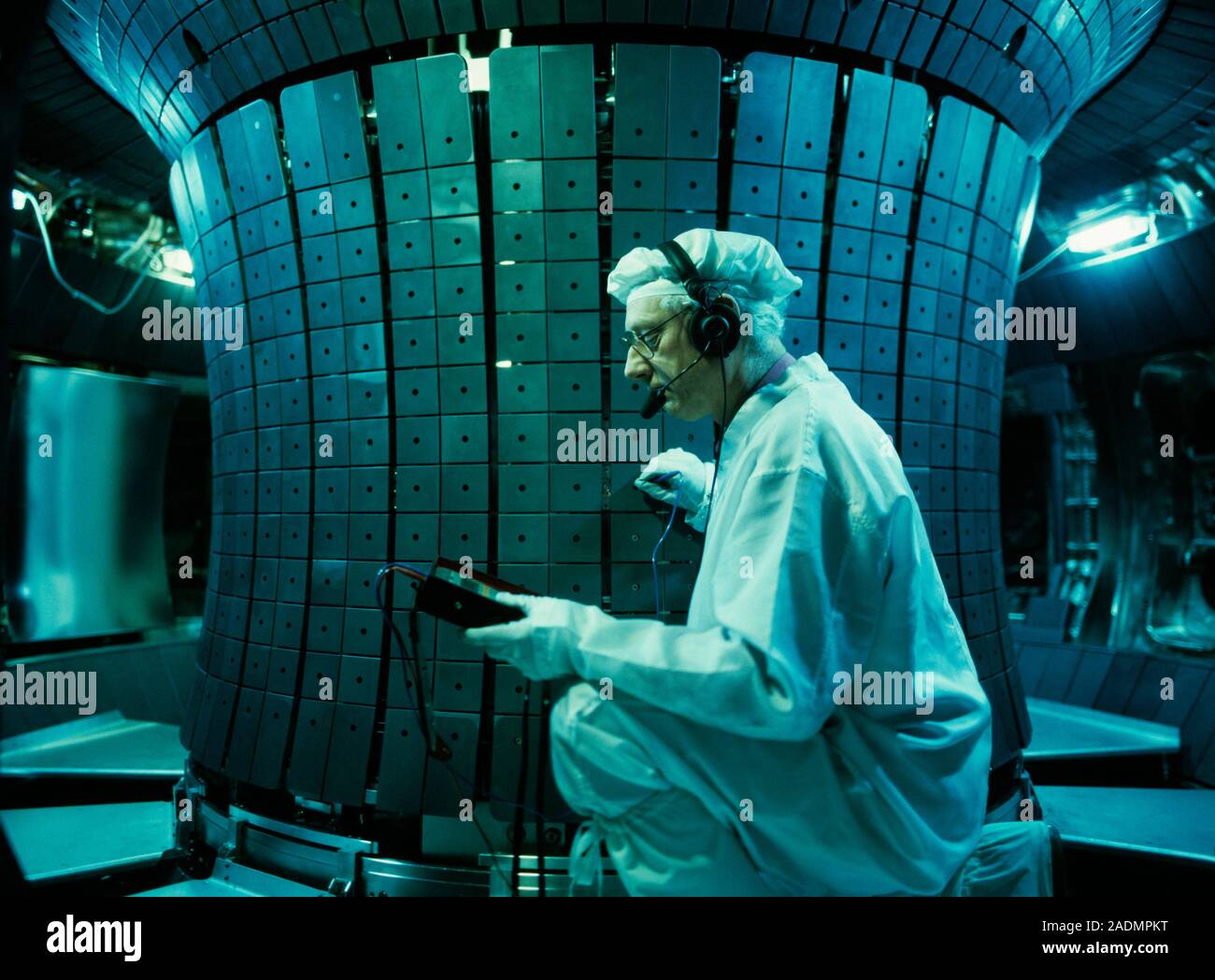Fusion reactor maintenance. Technician in the interior of a Tokamak ...