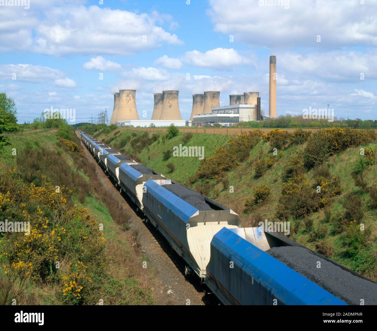 Coal-fired power station. Train transporting coal to a power station ...