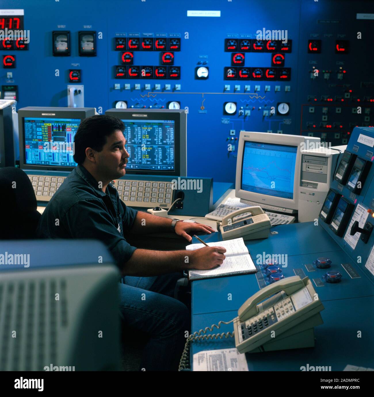 Power station control room. Technician in the control room of a coal ...