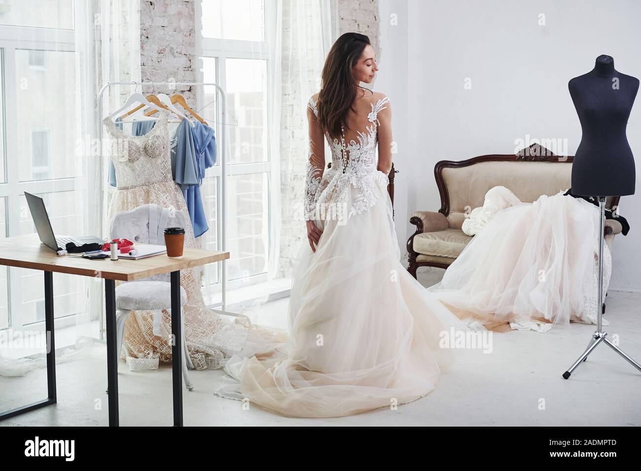 Happy with new wear. The process of fitting the dress in the studio of ...