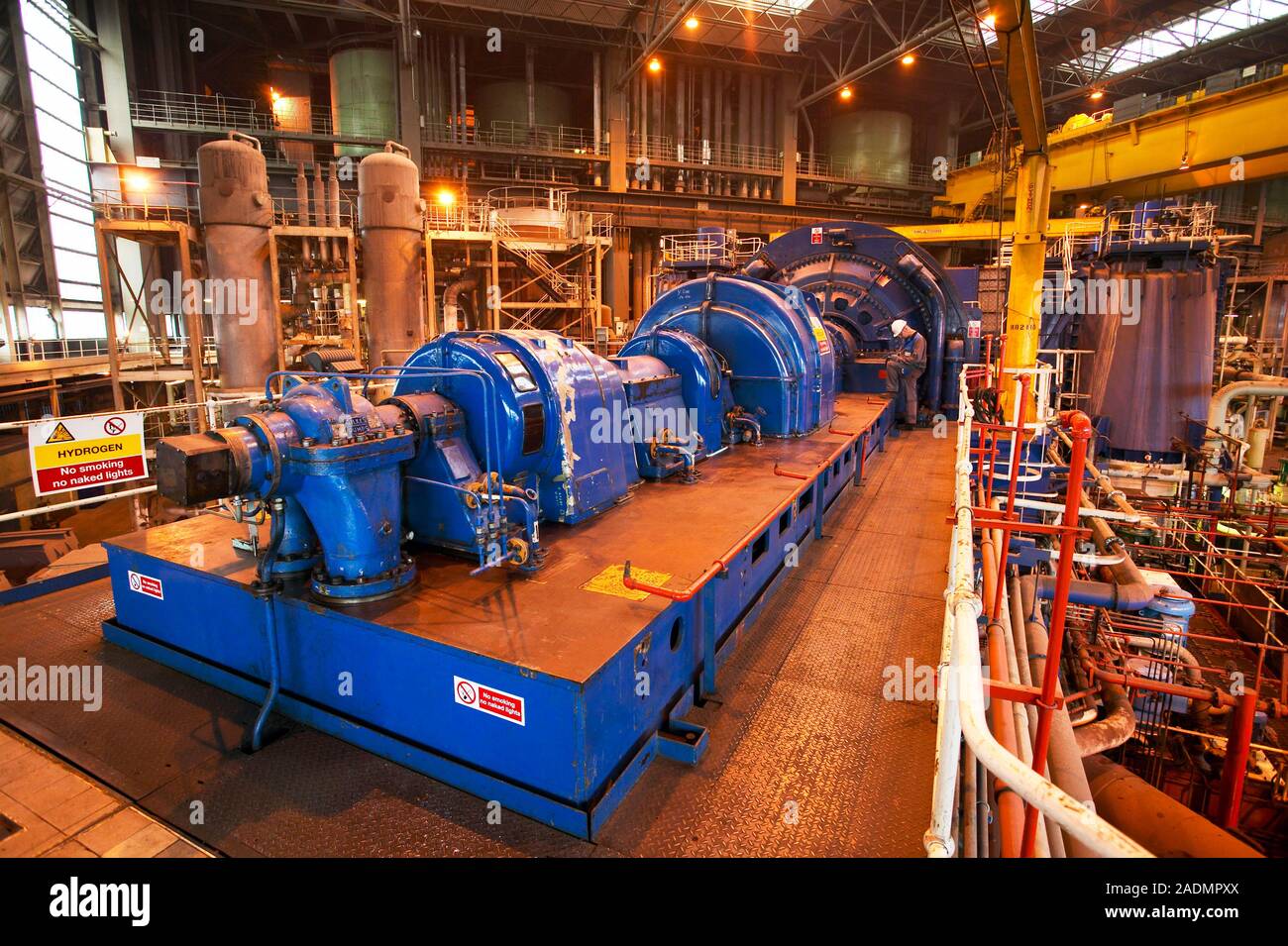 Power station turbine hall. Generator (background) and its exciter ...