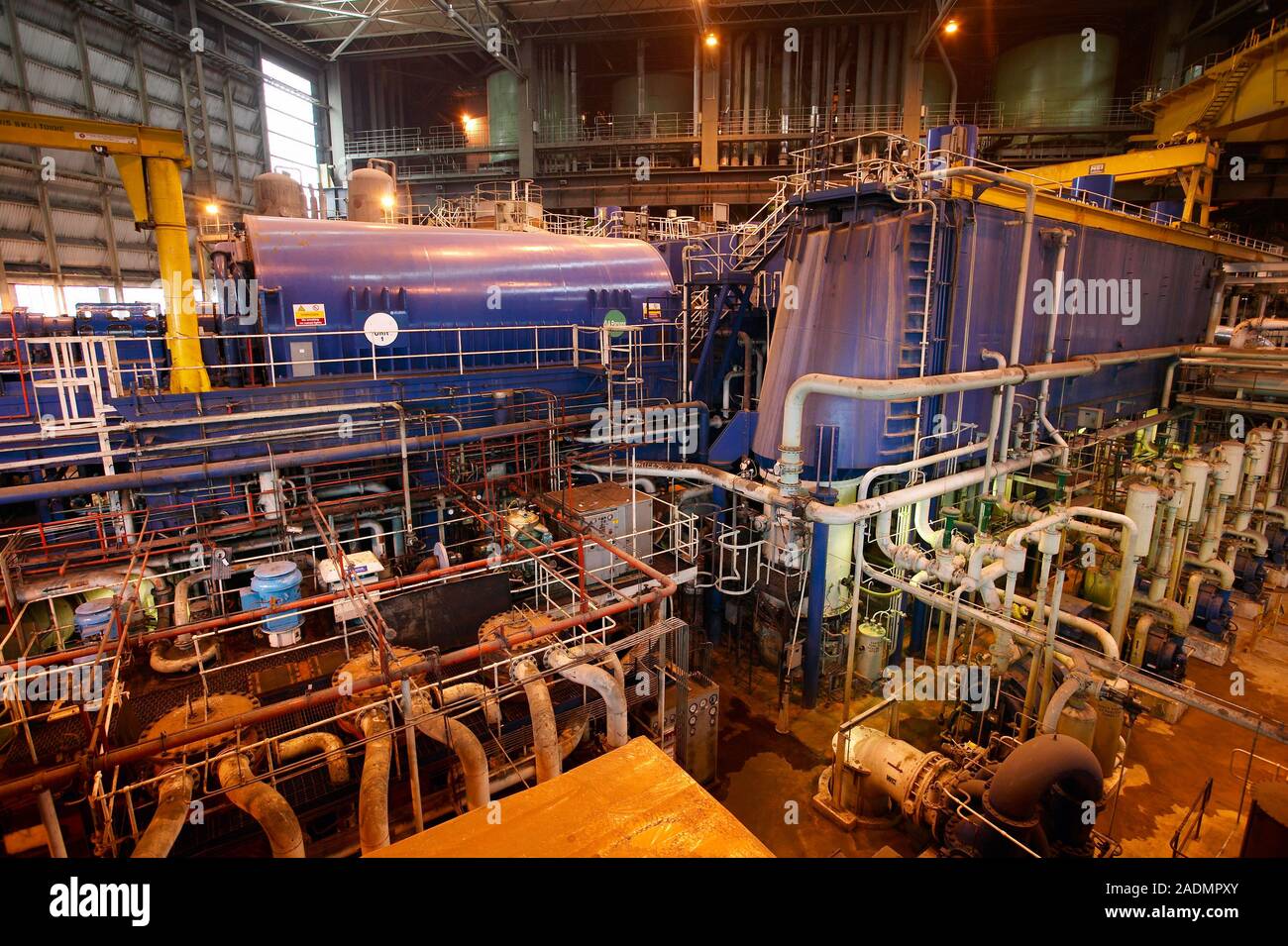 Power station turbine hall. Generator (left) and condenser (right, both ...