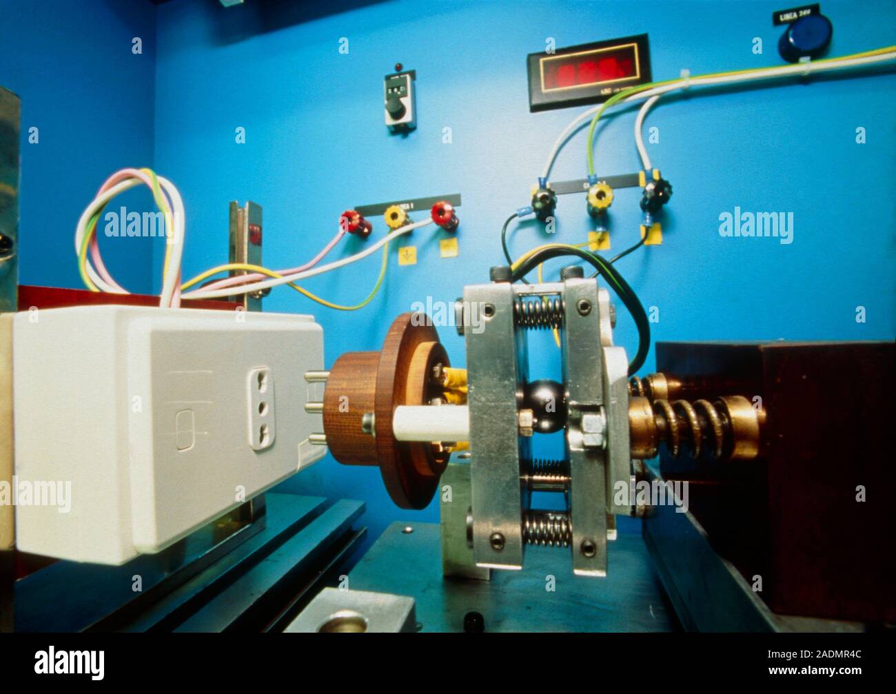 Quality control. Mechanical test on the quality of an electrical socket ...