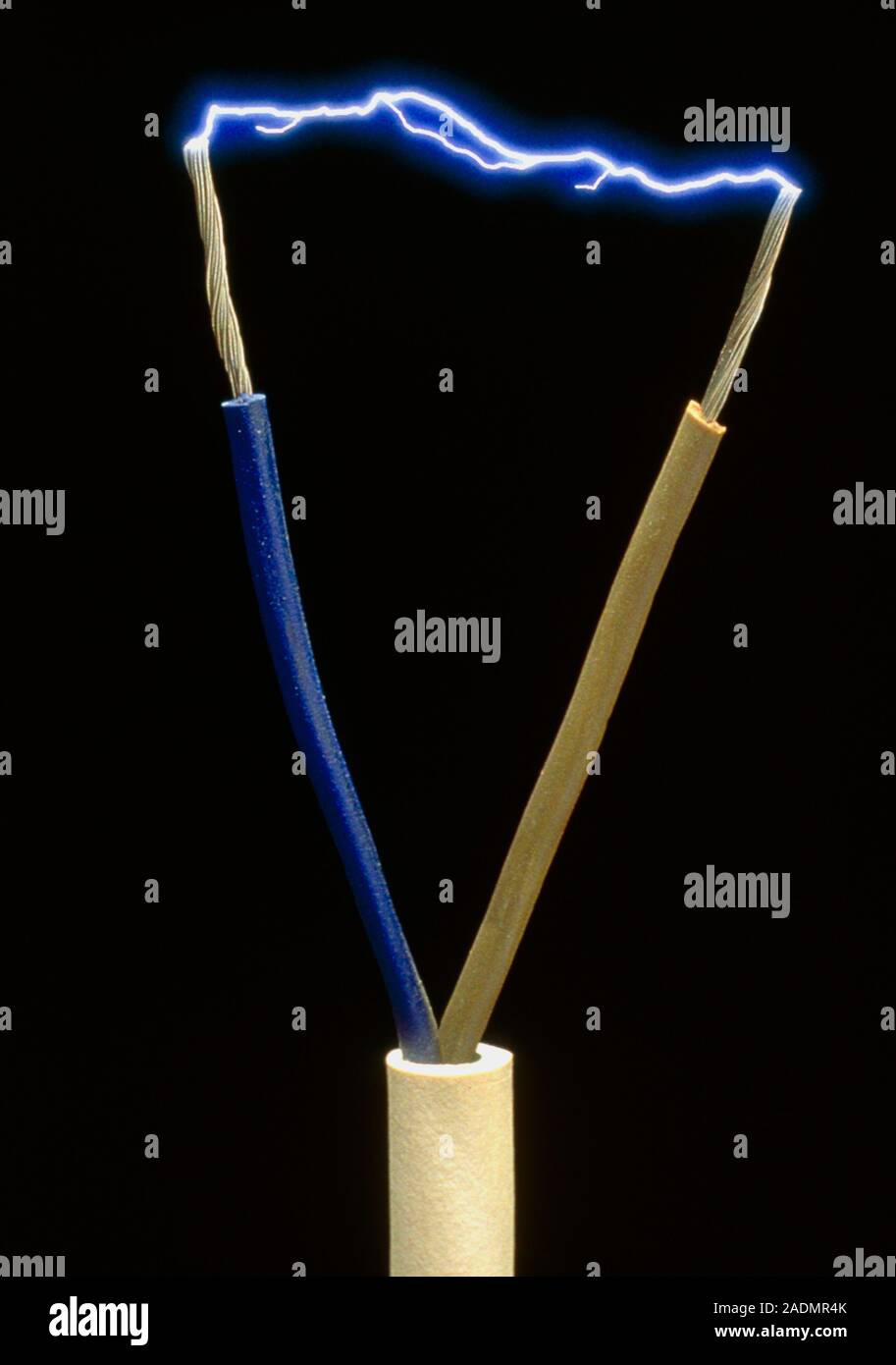 Spark discharge. Two exposed wires of a plug with a spark discharge ...