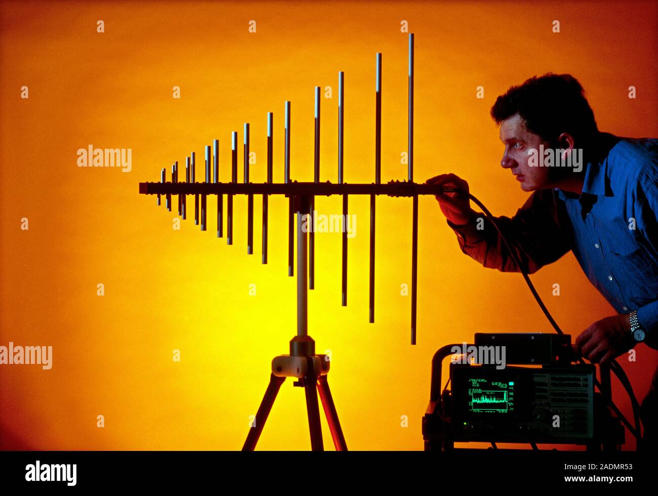 Electromagnetic measurement. Technician with an antenna for measuring ...