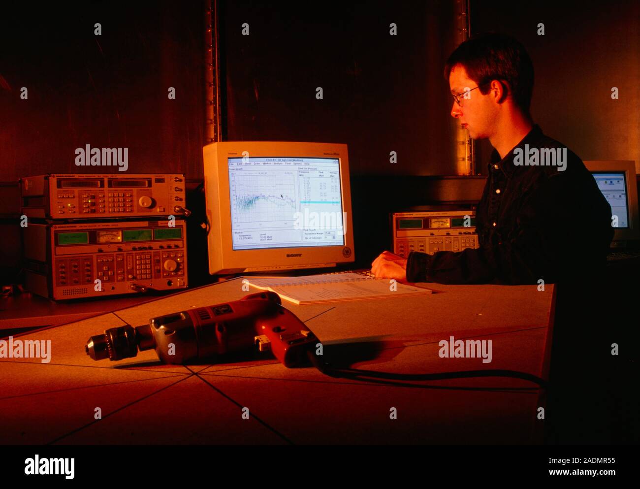 Electromagnetic measurement. Technician with an antenna for measuring ...