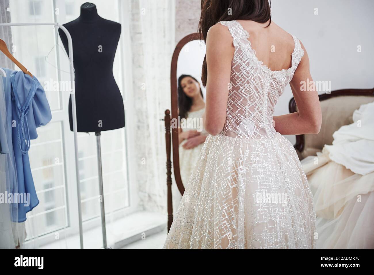 Close up view. The process of fitting the dress in the studio of hand ...