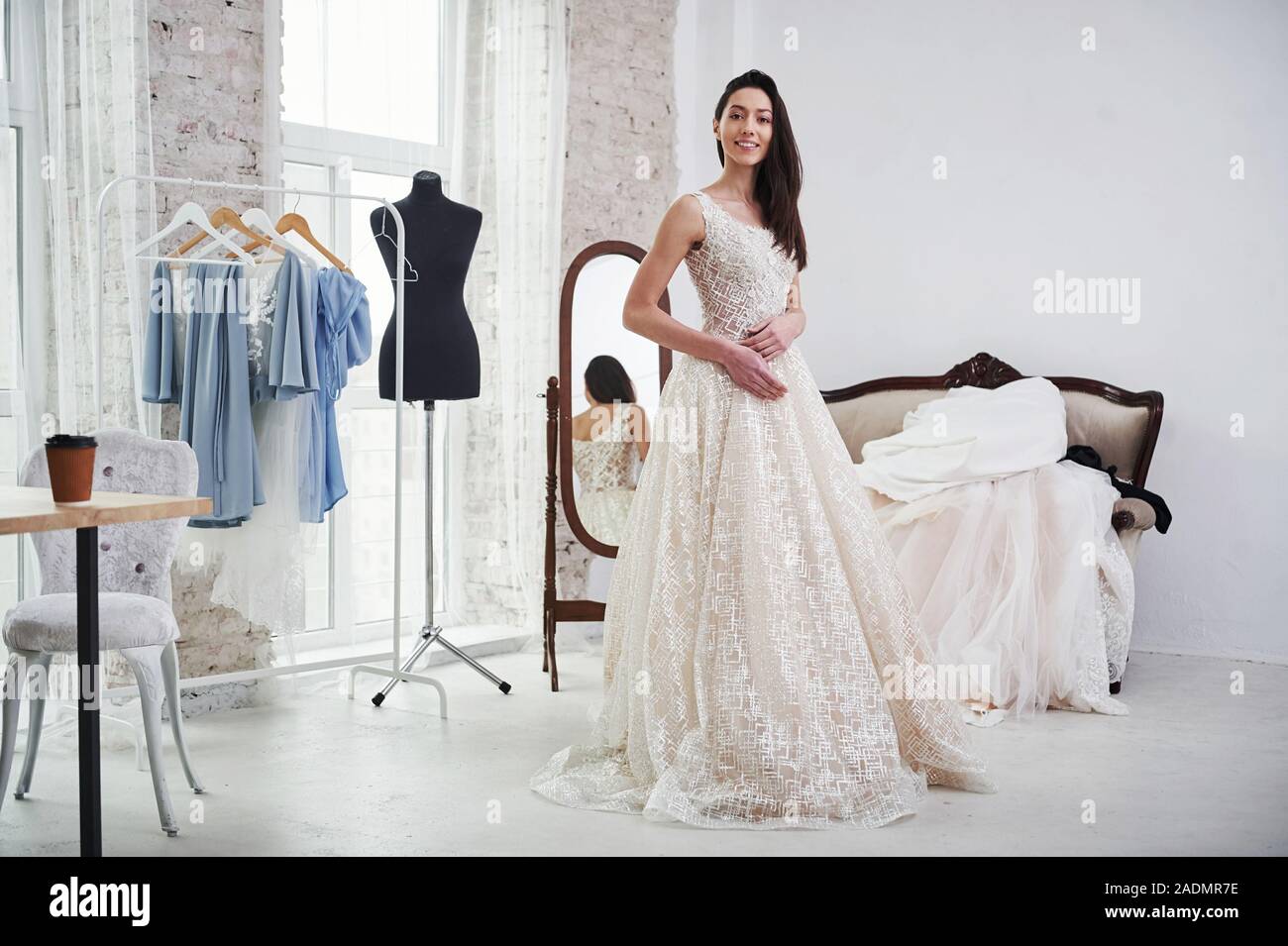 She satisfied. The process of fitting the dress in the studio of hand ...