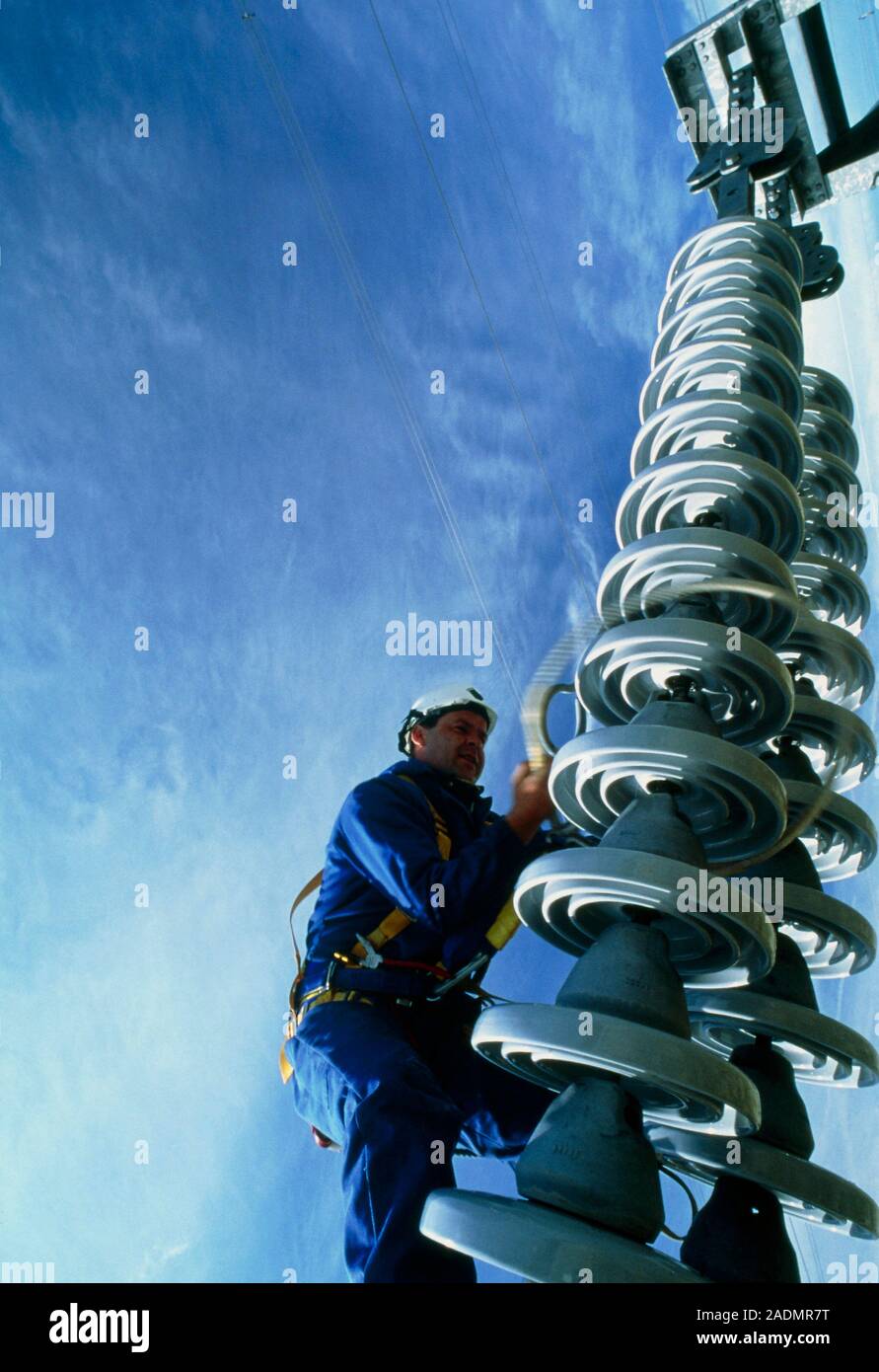 Electricity pylon maintenance. View of a technician working on the ...