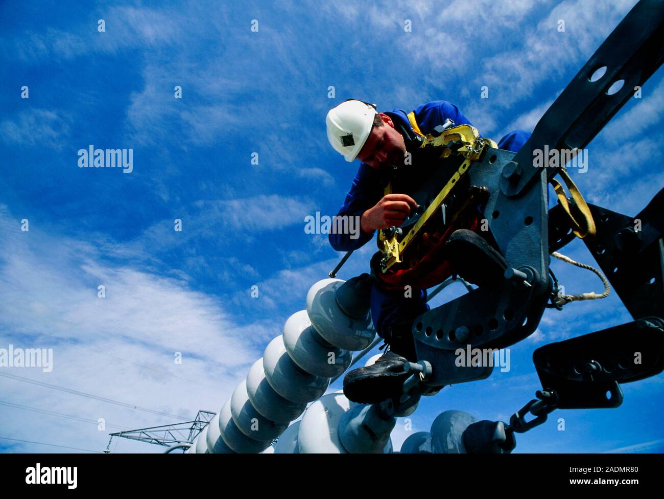 Electricity pylon maintenance. View of a technician working on the ...