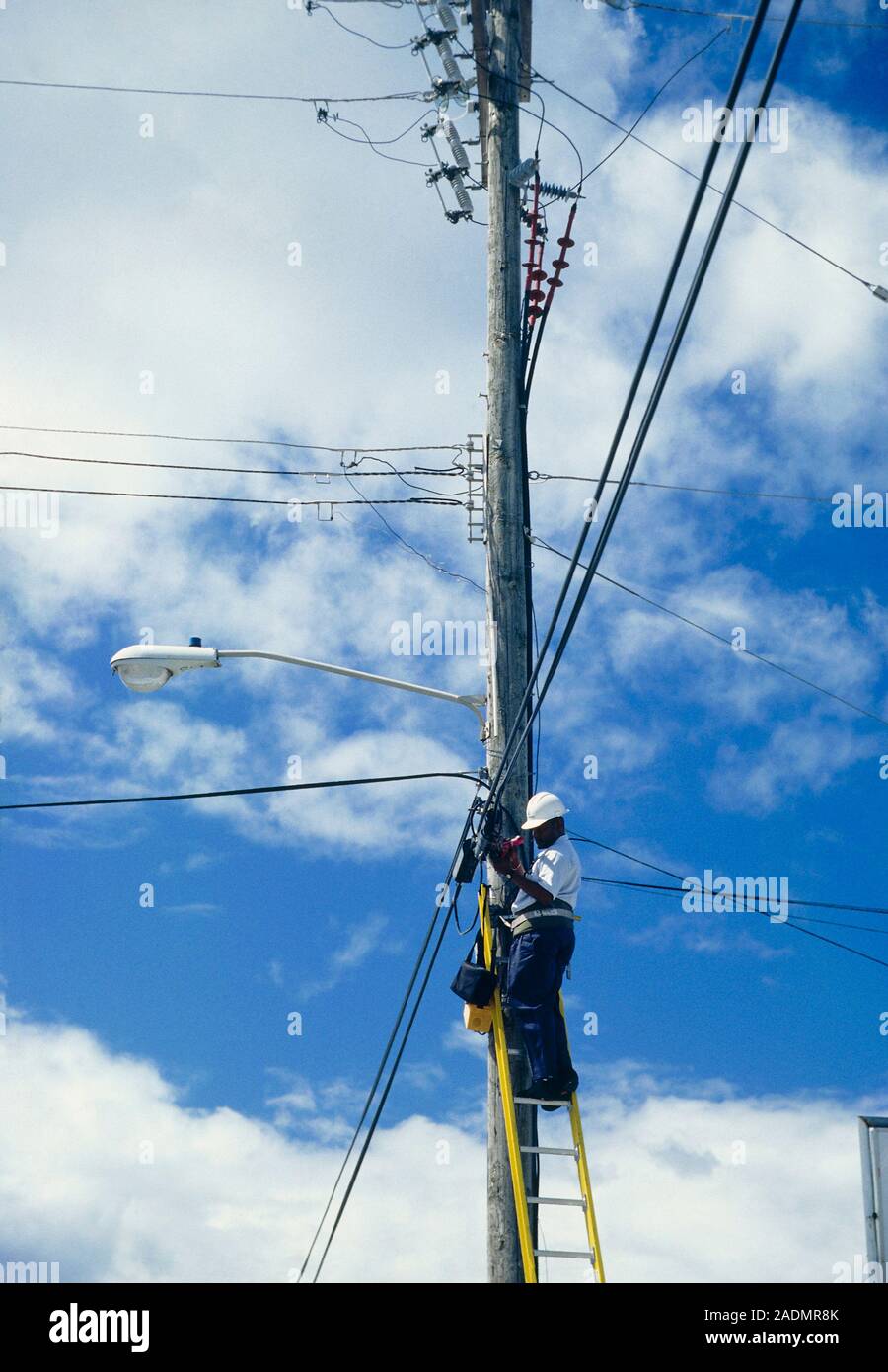 Power line repair. Electrical engineer repairing power lines. He is ...