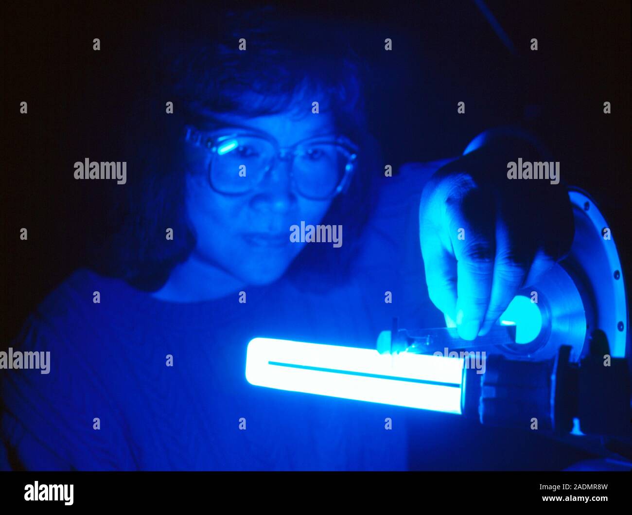 Lamp research. Researcher measuring the light output from a blue ...