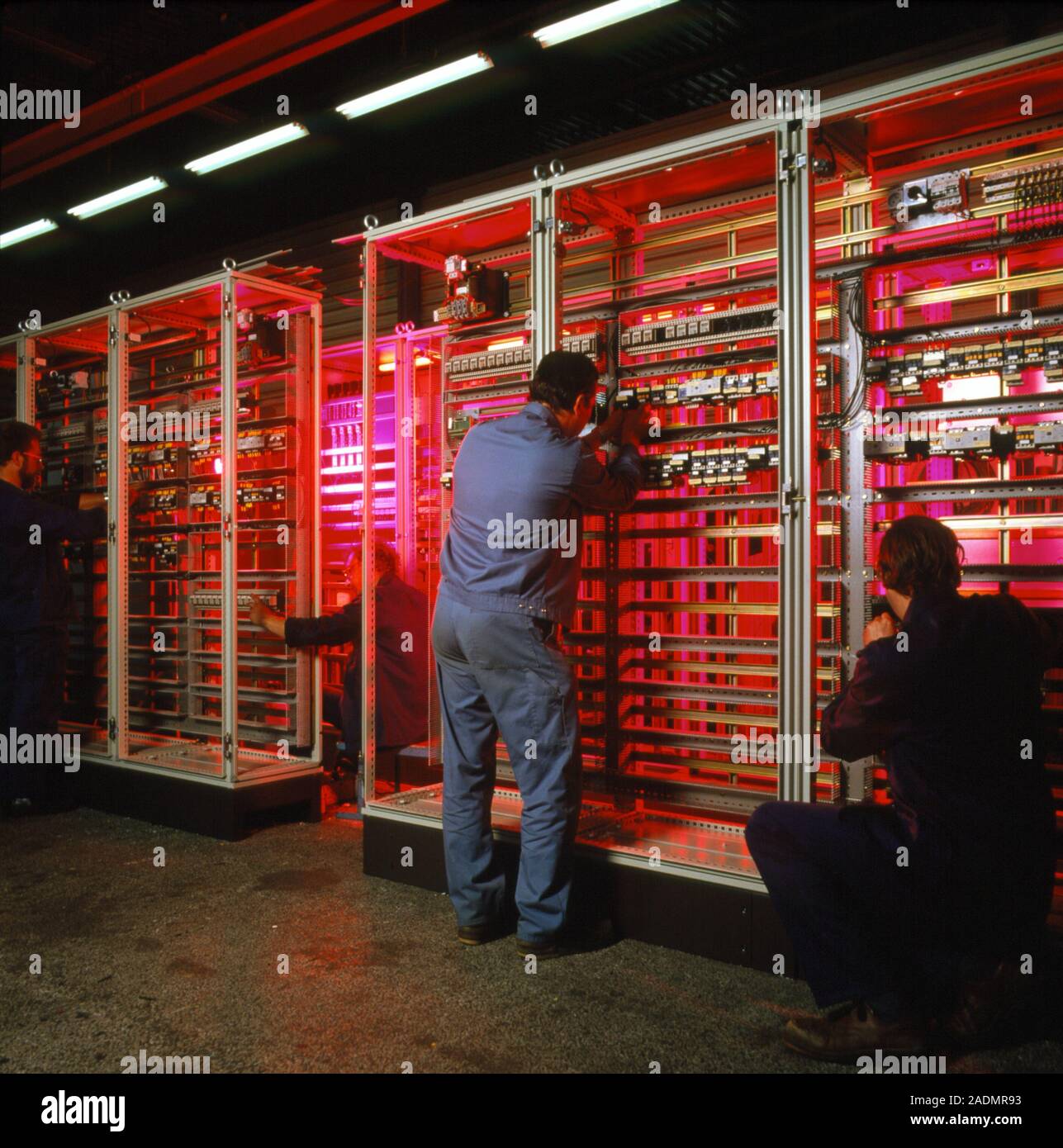 POSED BY MODELS. Circuit maintenance. Electricians working to fit and ...