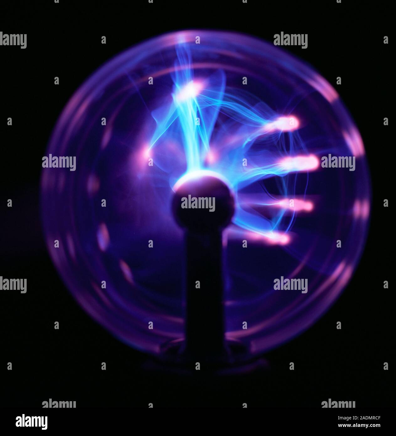 Plasma sphere. Hand touching a plasma sphere and attracting streamers ...