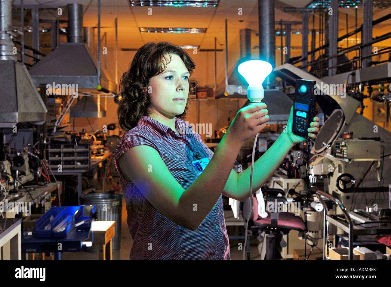 Light bulb research. Researcher measures the brightness of a prototype ...