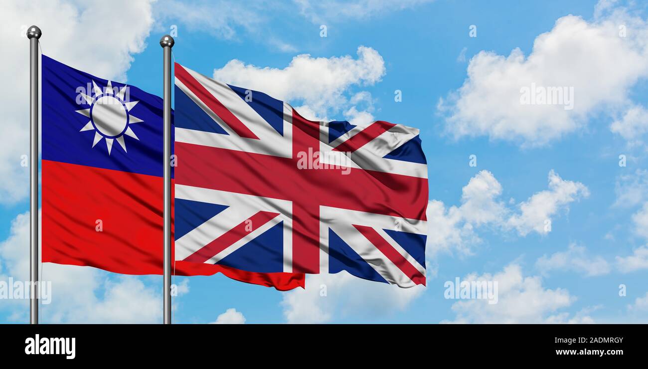 Taiwan and United Kingdom flag waving in the wind against white cloudy ...