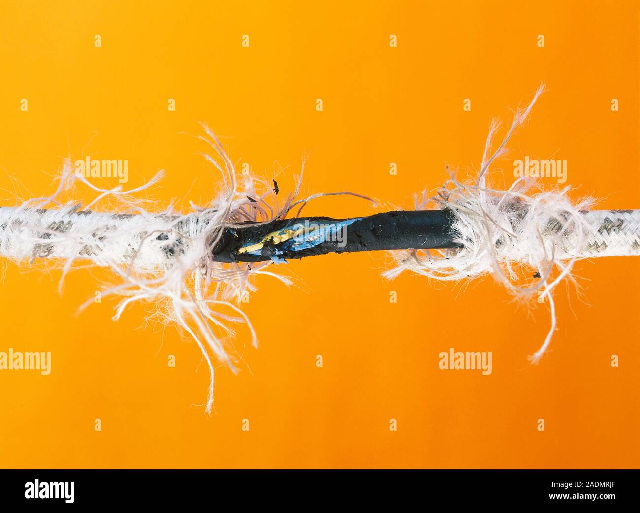 Worn electrical wire. Loss of the surrounding insulation has exposed ...