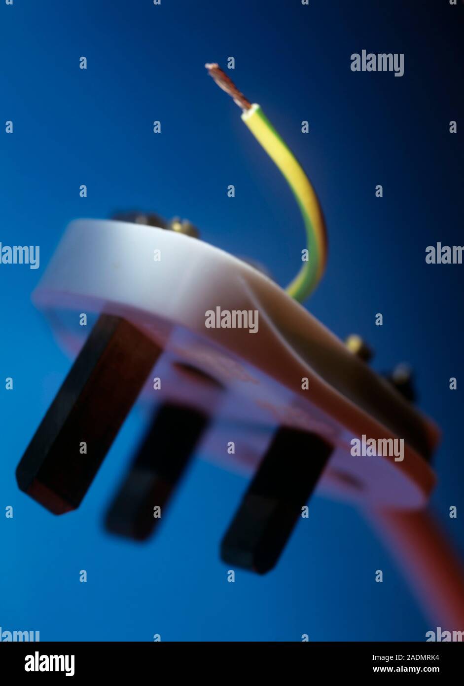 Electrical plug. Open three pin plug showing an exposed earth wire ...