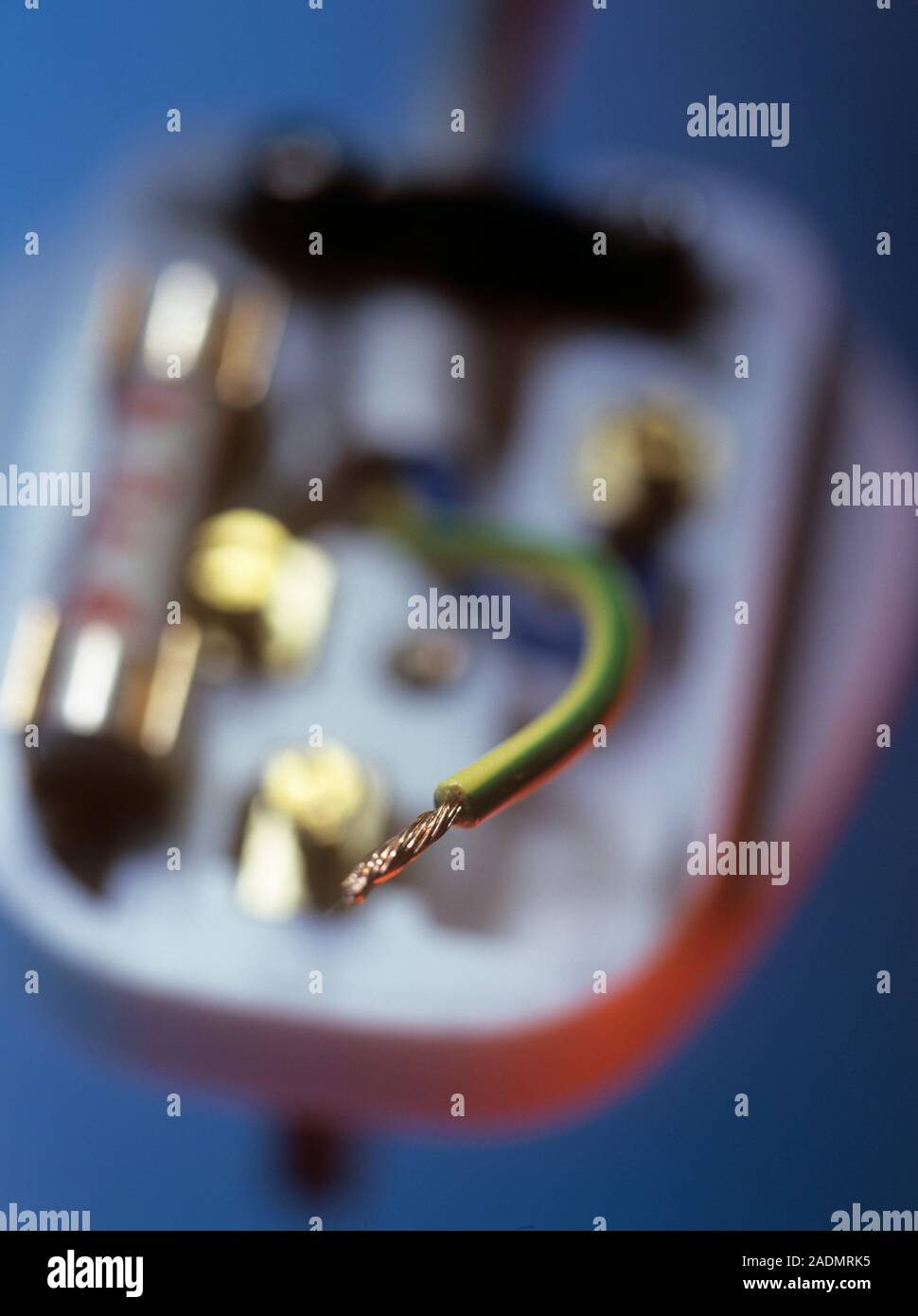 Electrical plug. Open three pin plug showing an exposed earth wire ...