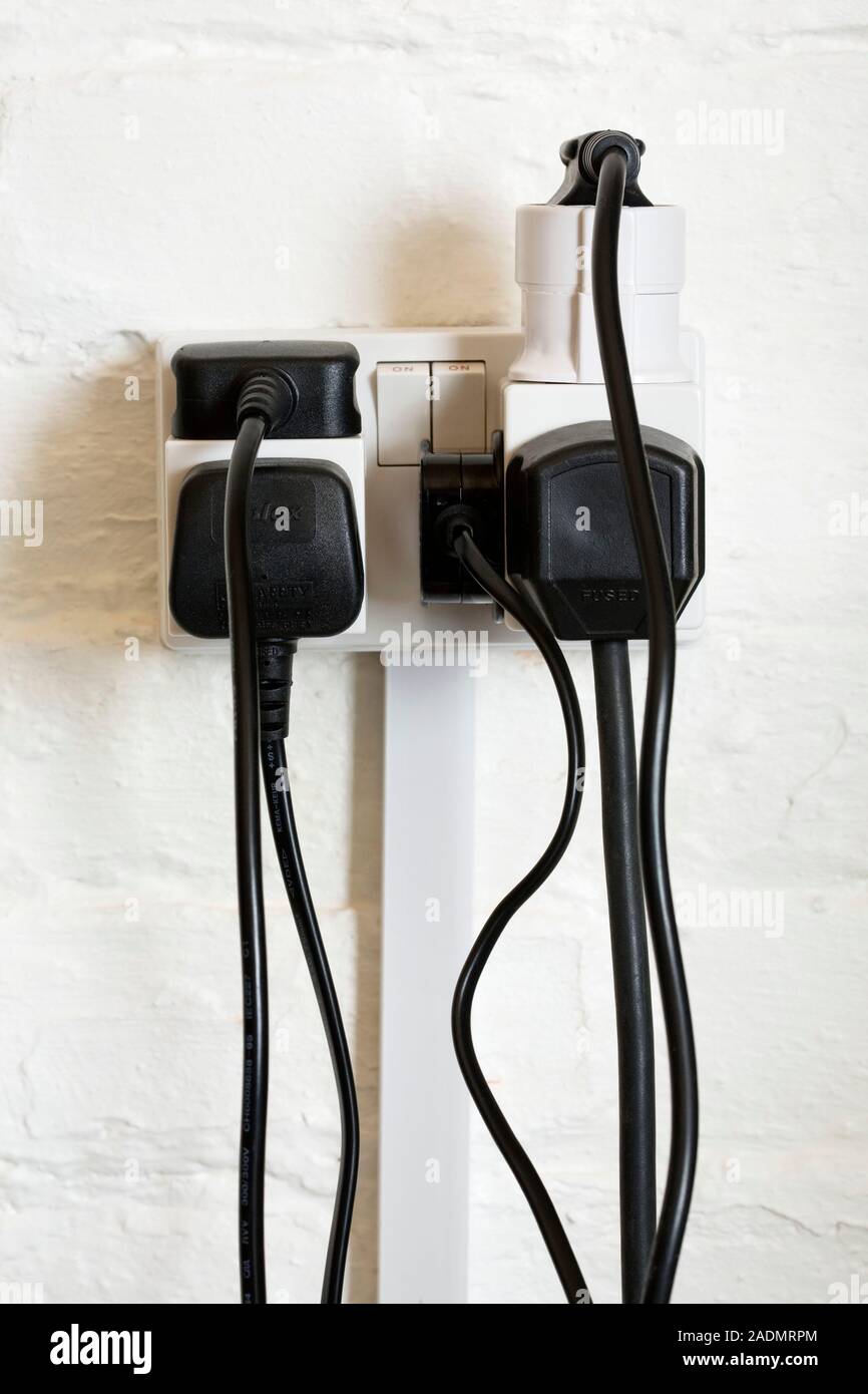 Overloaded electrical power socket. Power sockets containing a plug ...