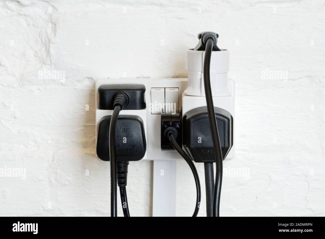 Overloaded electrical power socket. Power sockets containing a plug ...
