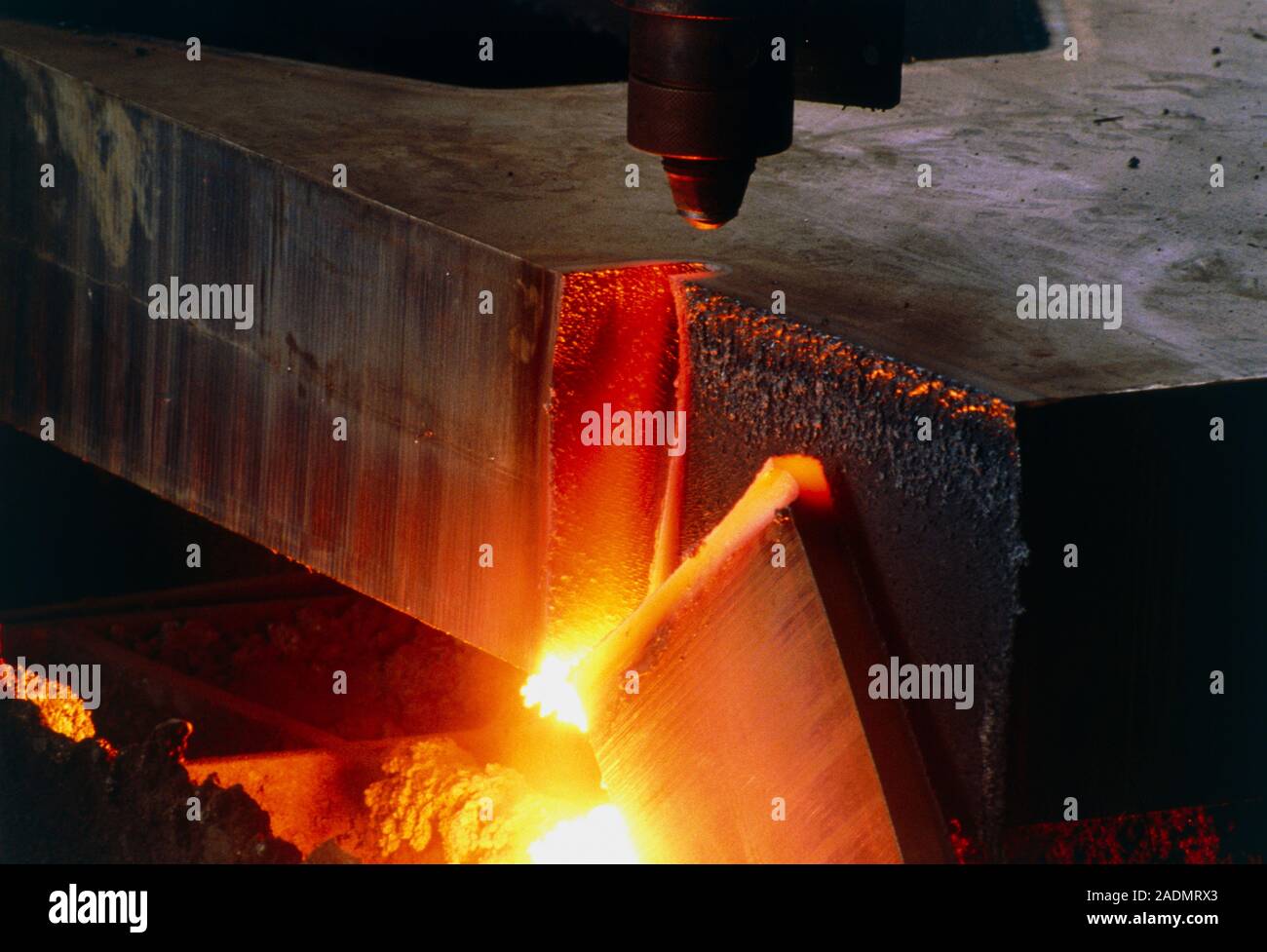 Laser cutting. View of a block of stainless steel being cut by an ...