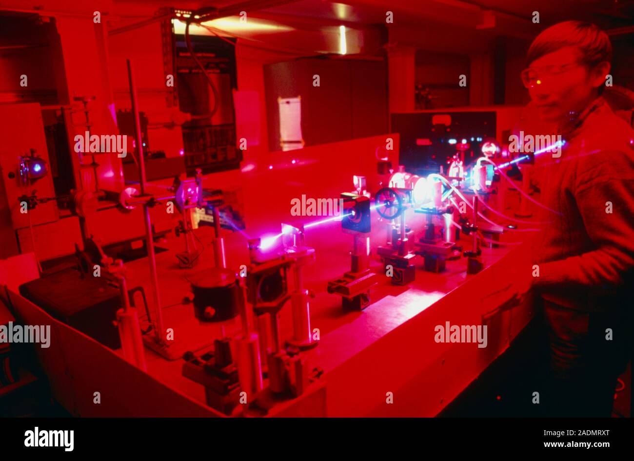 Scientist observing the beam from an ultraviolet tunable dye laser ...