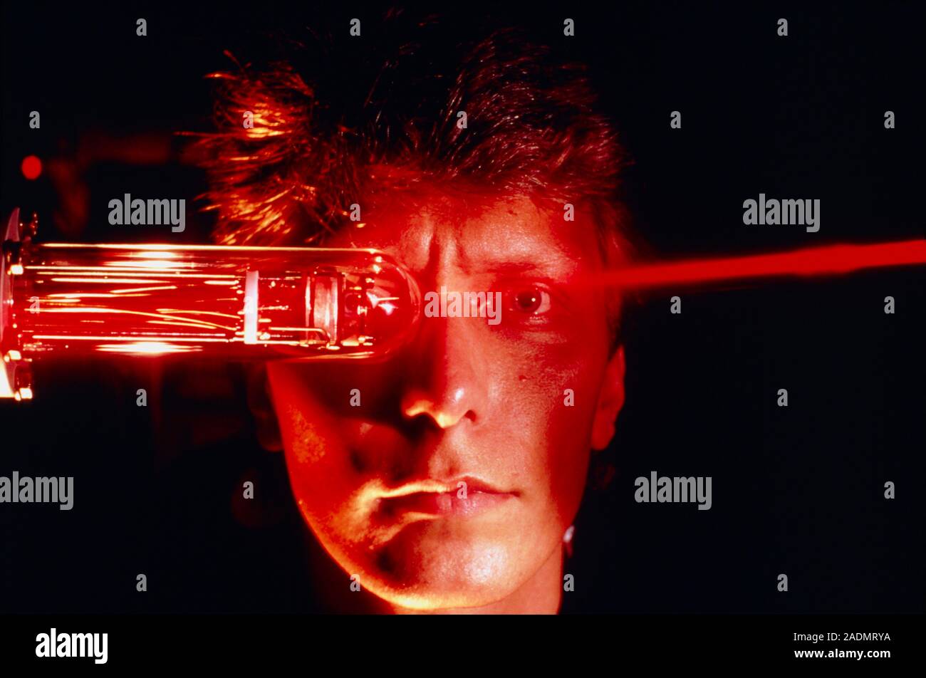 A German physicist looking at a laser beam entering the ion trap ...