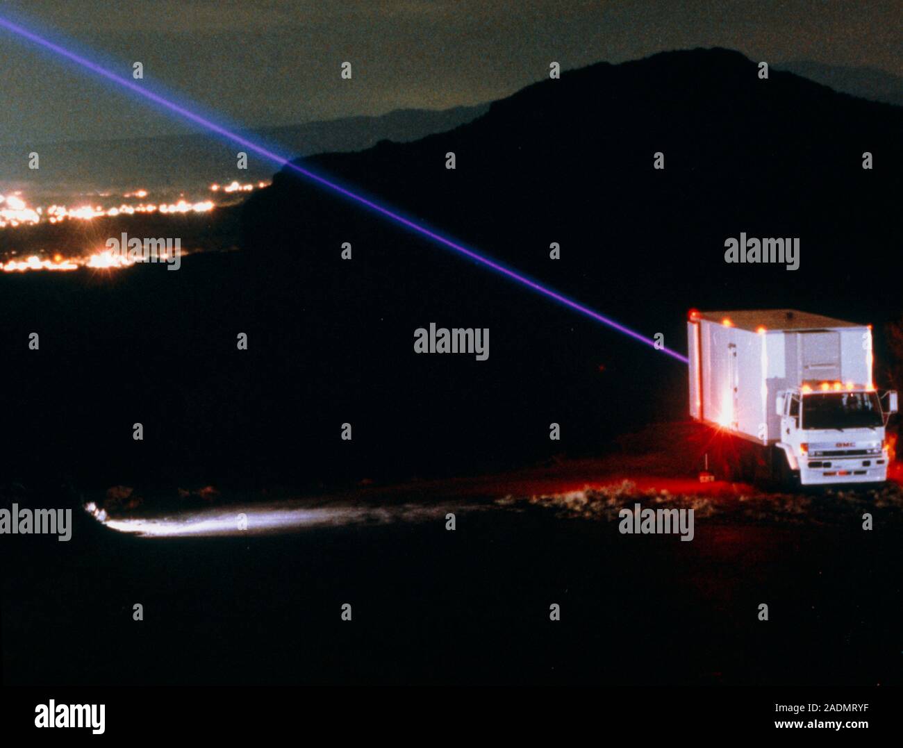Lidar air pollution monitoring. The laser beam of a Lidar unit being ...