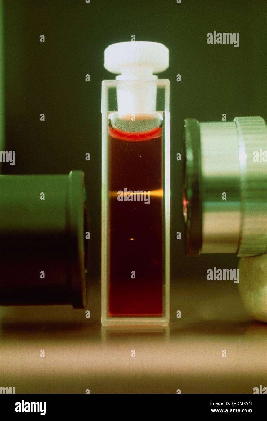 Pinpoint of light. Cuvette with dye showing the pinpoint of light ...