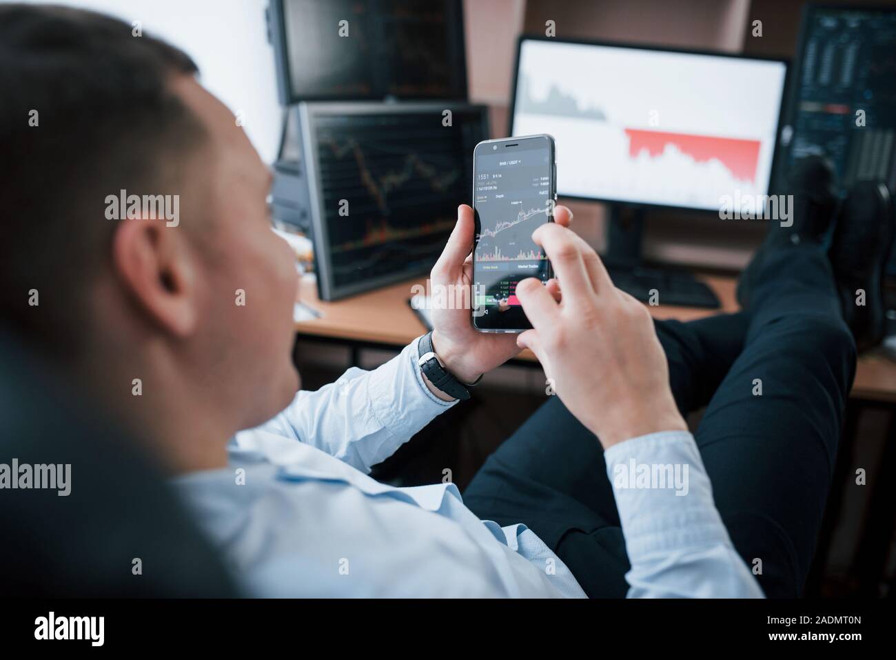 Scrolling some other graphs. Man working online in the office with ...