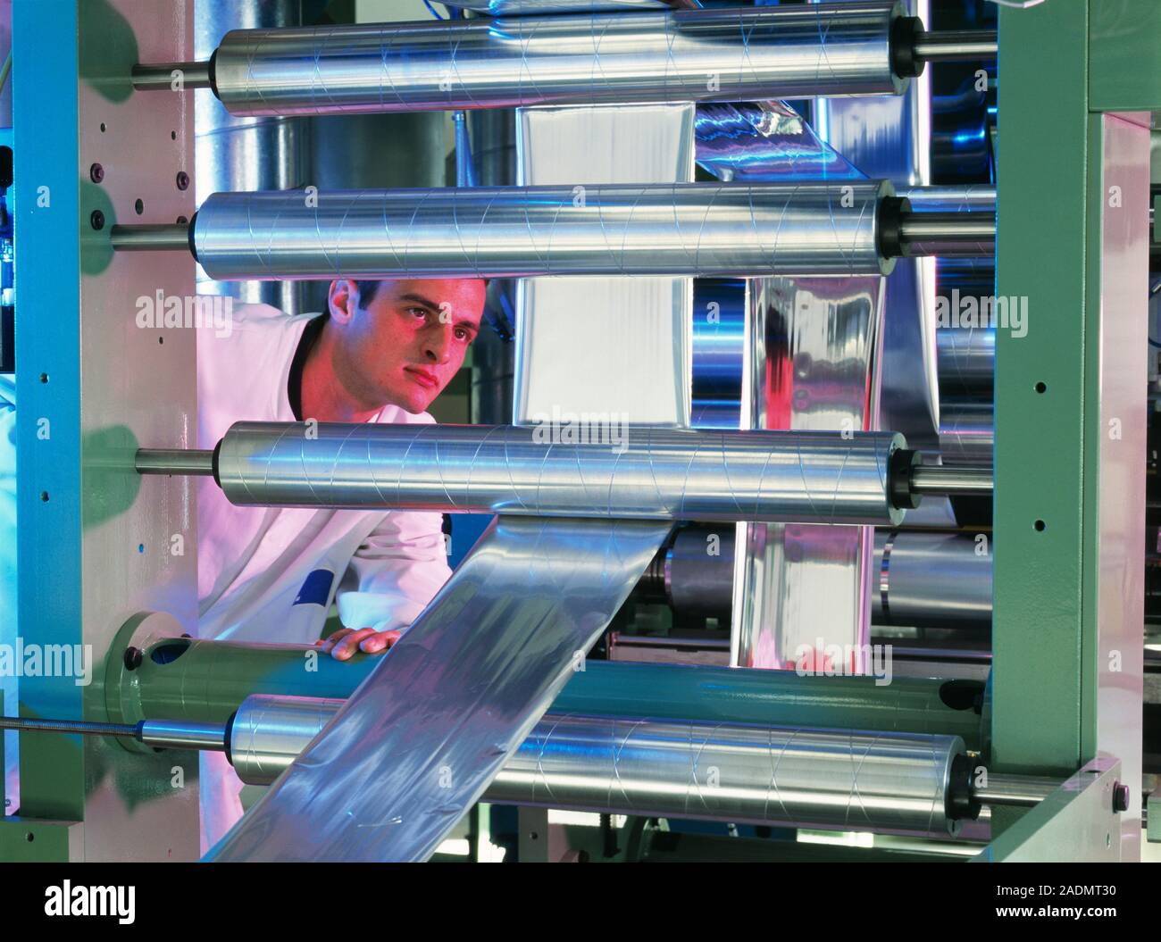 Holography. Holographic technician examining a machine being used to ...