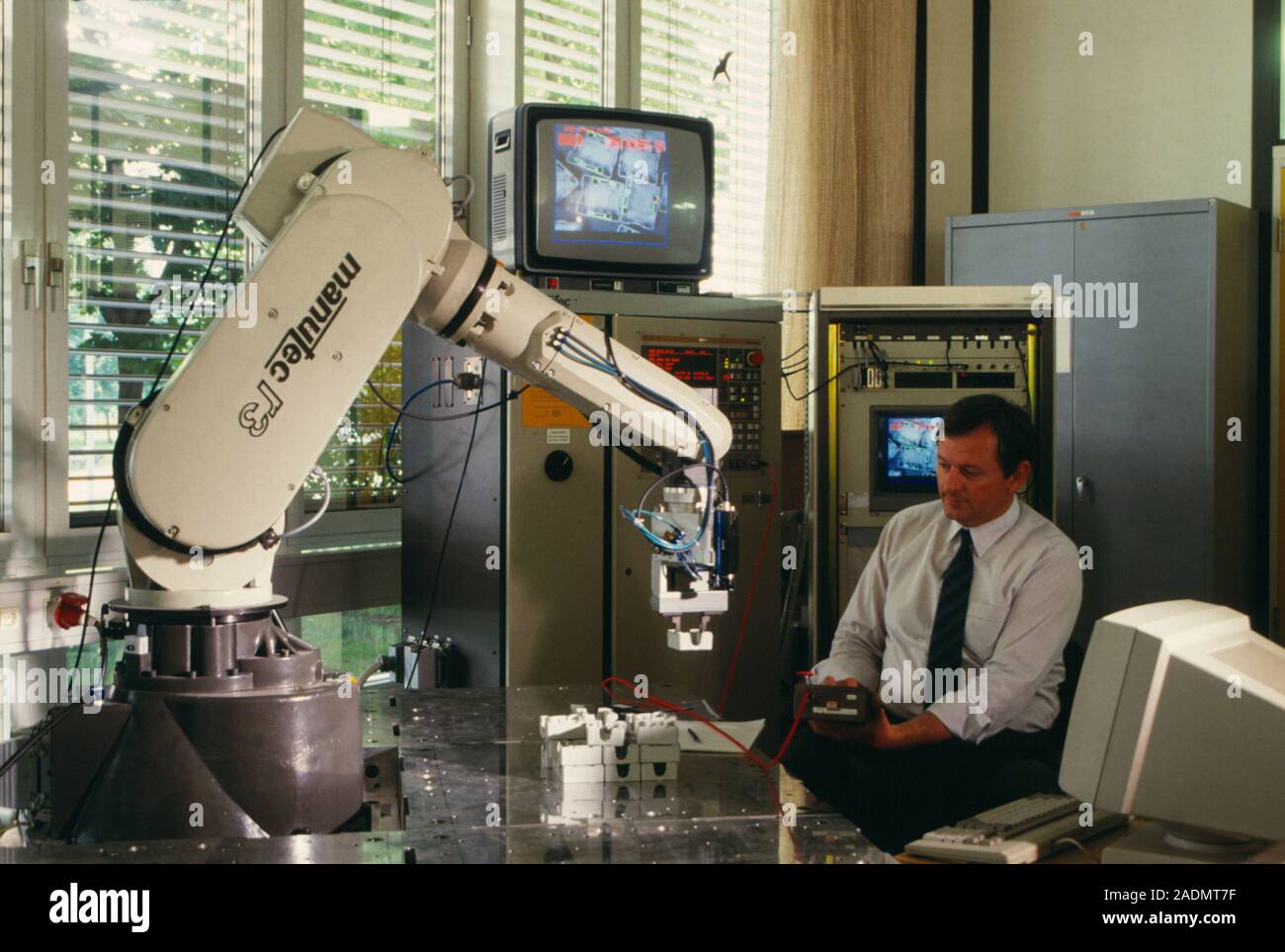 Robotic arm. Roboticist manipulating objects using a remote-controlled ...