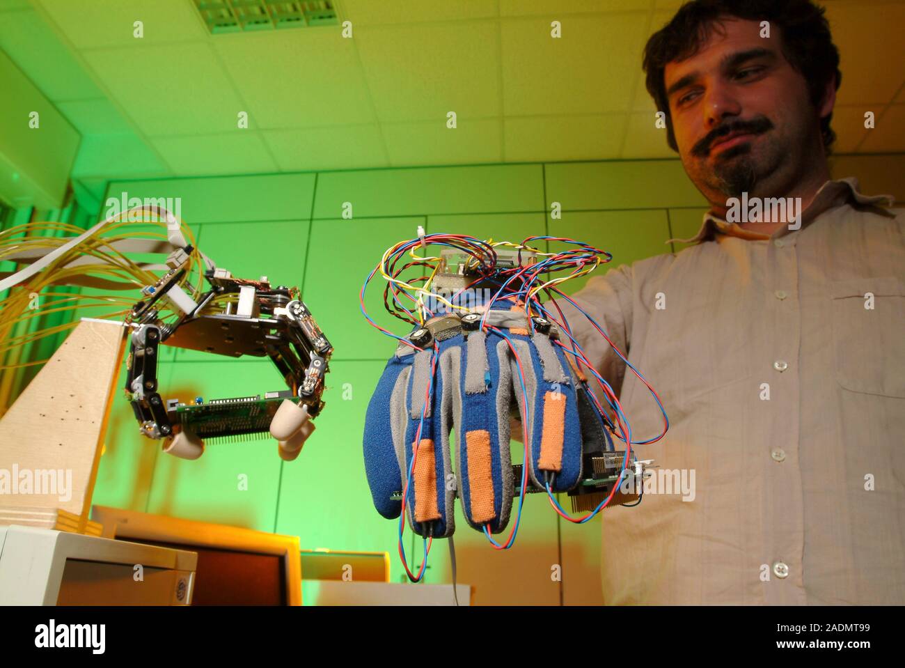 Robotic hand control system. Researcher using a master/slave robotic ...
